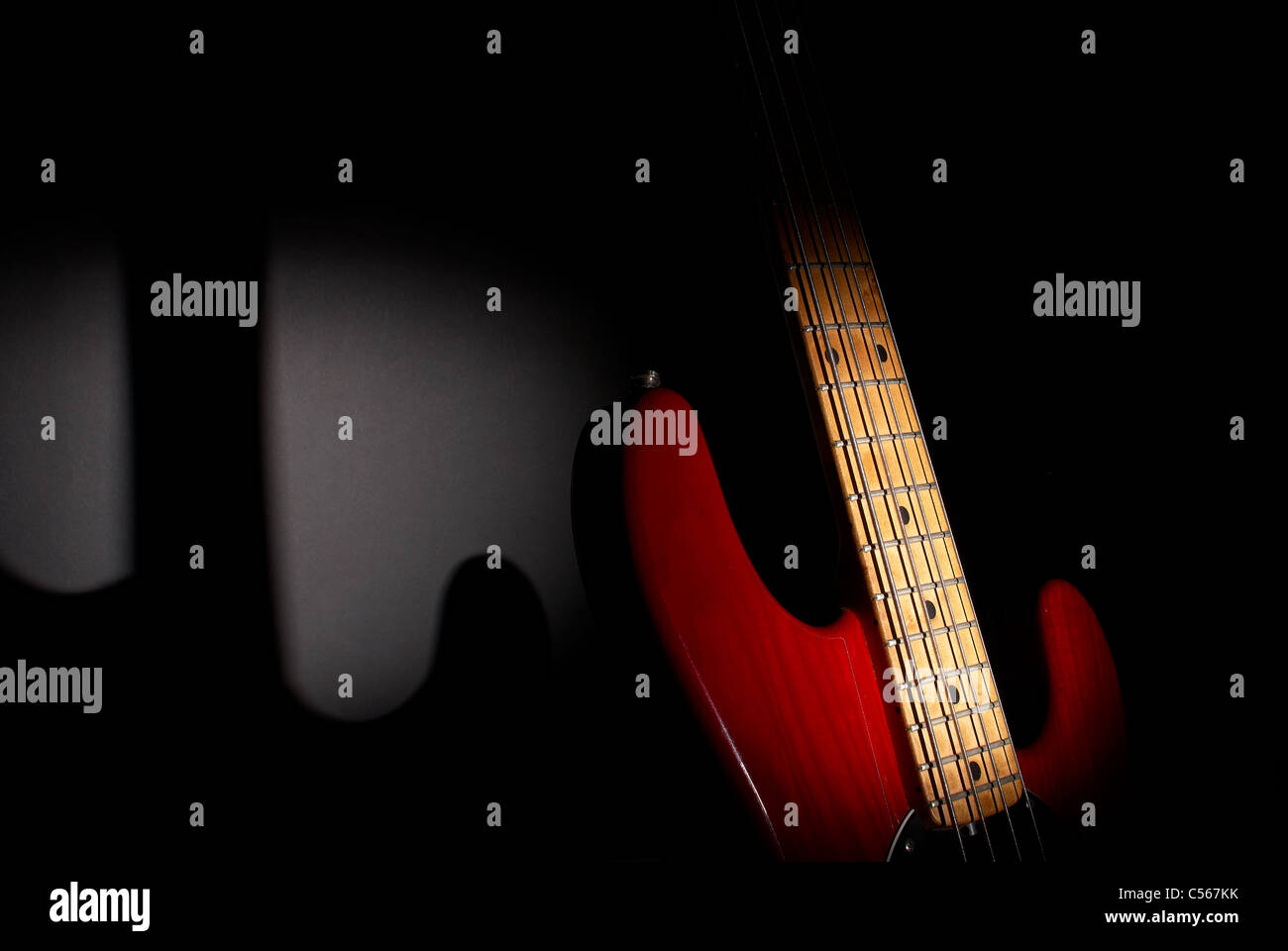 Wooden four string fretted electric bass instrument Stock Photo - Alamy