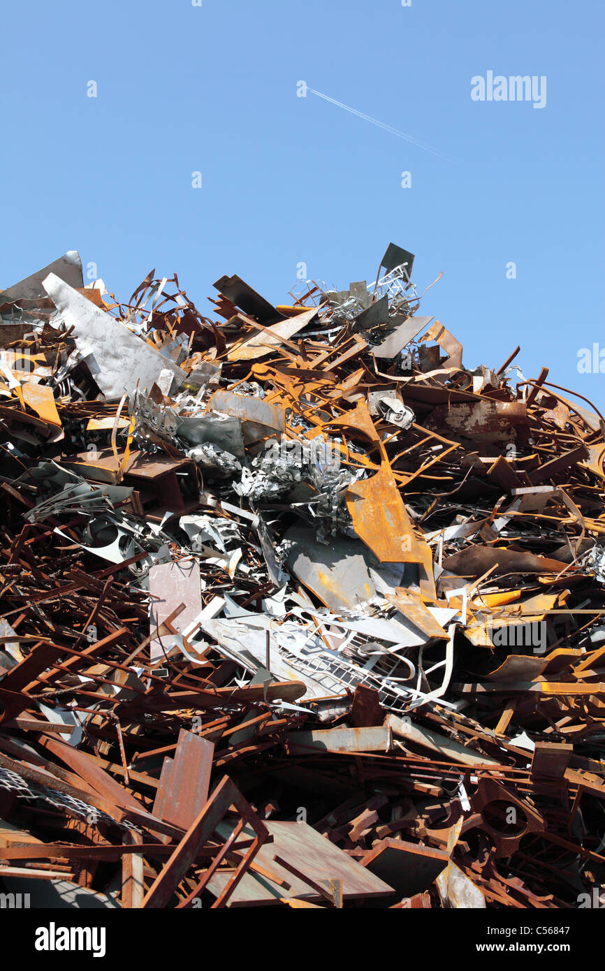 Stack of scrap metal against blue sky Stock Photo - Alamy