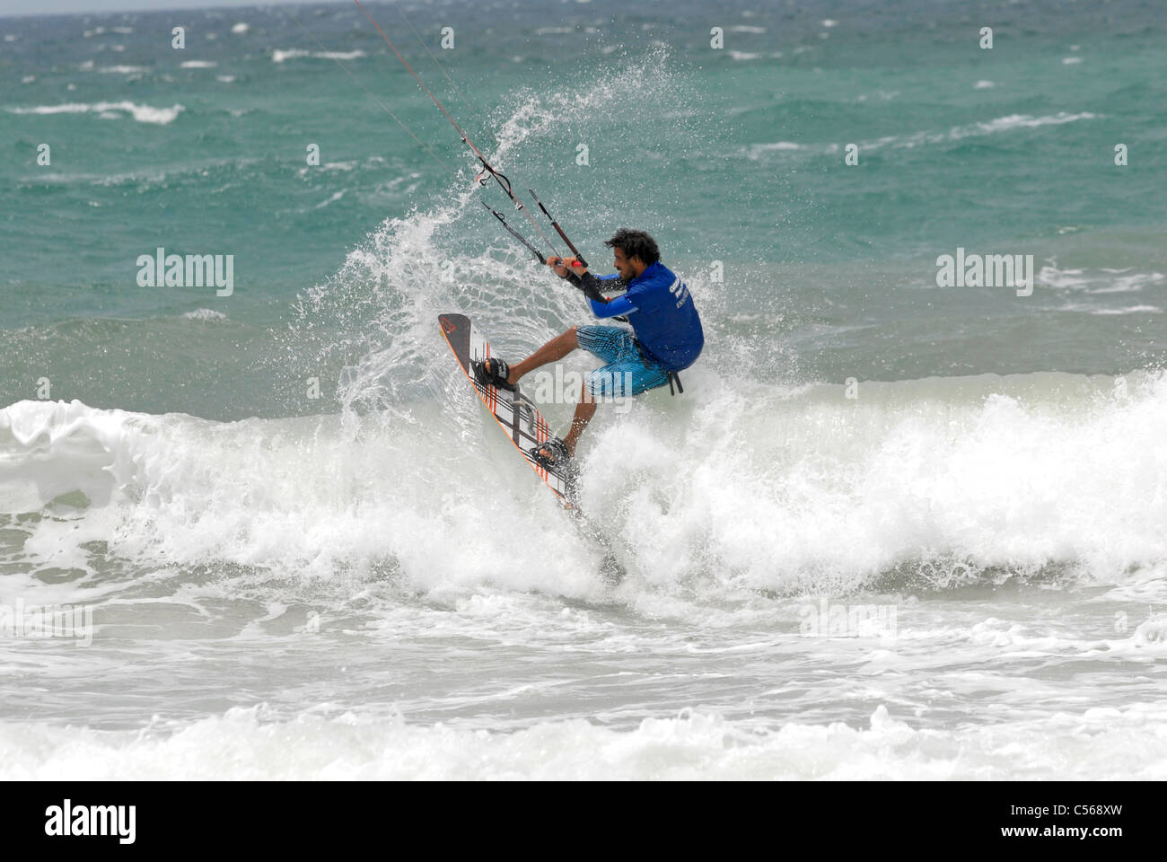 Kite surfer crashing through wave Stock Photo - Alamy