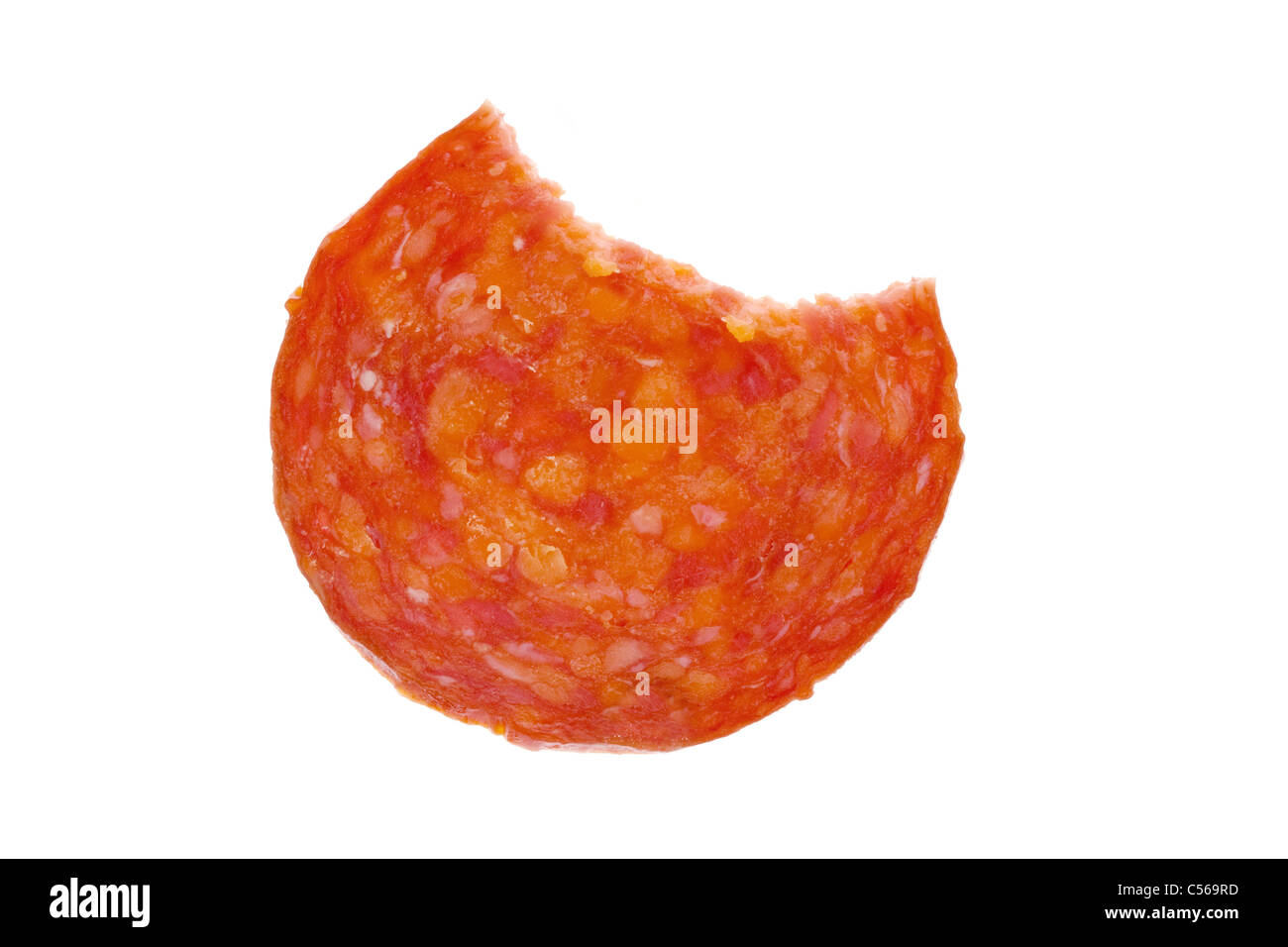 Single slice of salami with a missing bite over white Stock Photo - Alamy