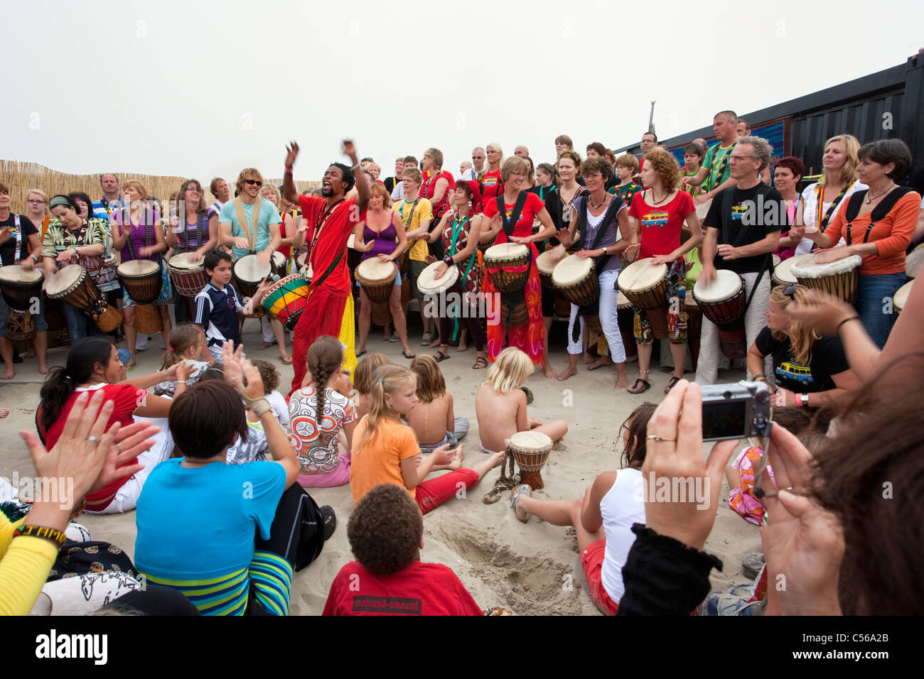 The Netherlands, IJmuiden, Djembe or percussion demonstration on beach ...