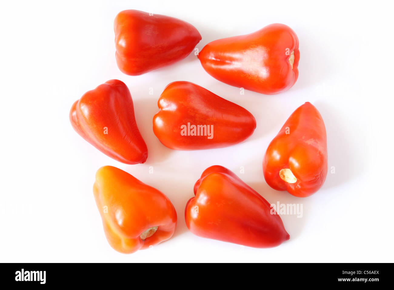 Seven salad red pepper on a white background Stock Photo - Alamy