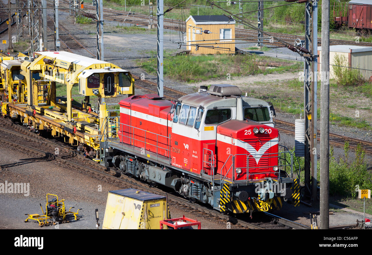 Diesel electric locomotive pulling rail setting , maintenance and rail ...