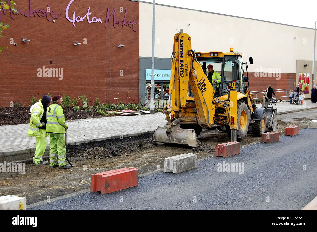 Breaking and clearing debris from old road to prepare for new surface ...