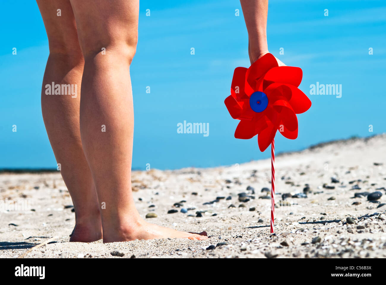 a red wind turbine on the sandy beach with two legs Stock Photo - Alamy