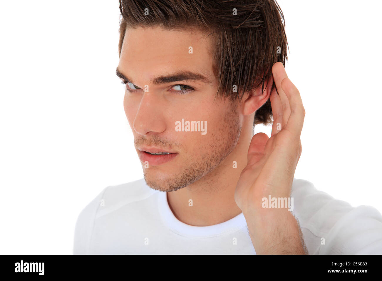 Young guy cant hear. All on white background Stock Photo - Alamy