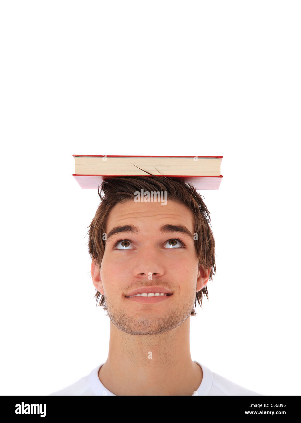 Attractive young man balancing a book on his head. Extra copy space on ...