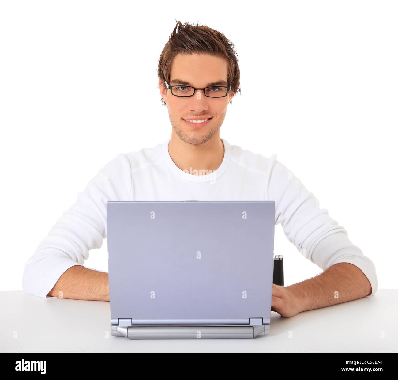 Smiling young guy using notebook computer. All on white background ...