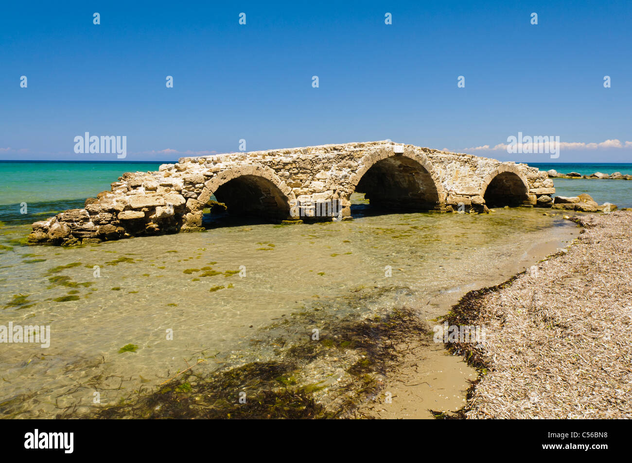 Stone bridge on a beach at the Greek town of Argassi Stock Photo - Alamy