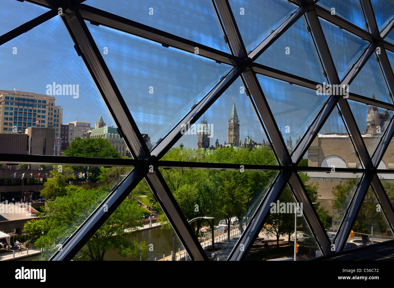 Parliament buildings and canal seen through the glass facade of the ...