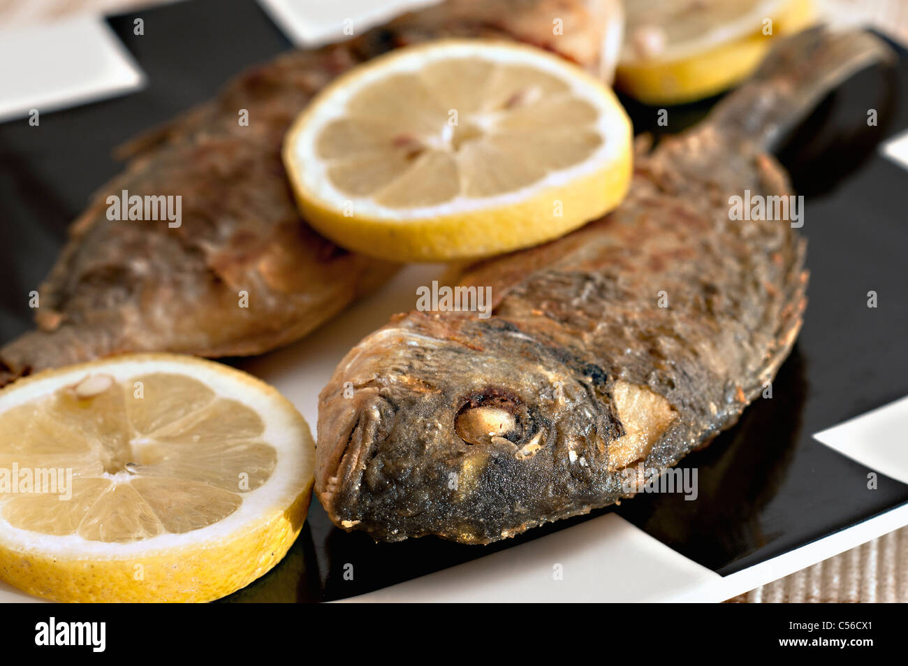 Cooked gilt-head bream with lemon Stock Photo - Alamy