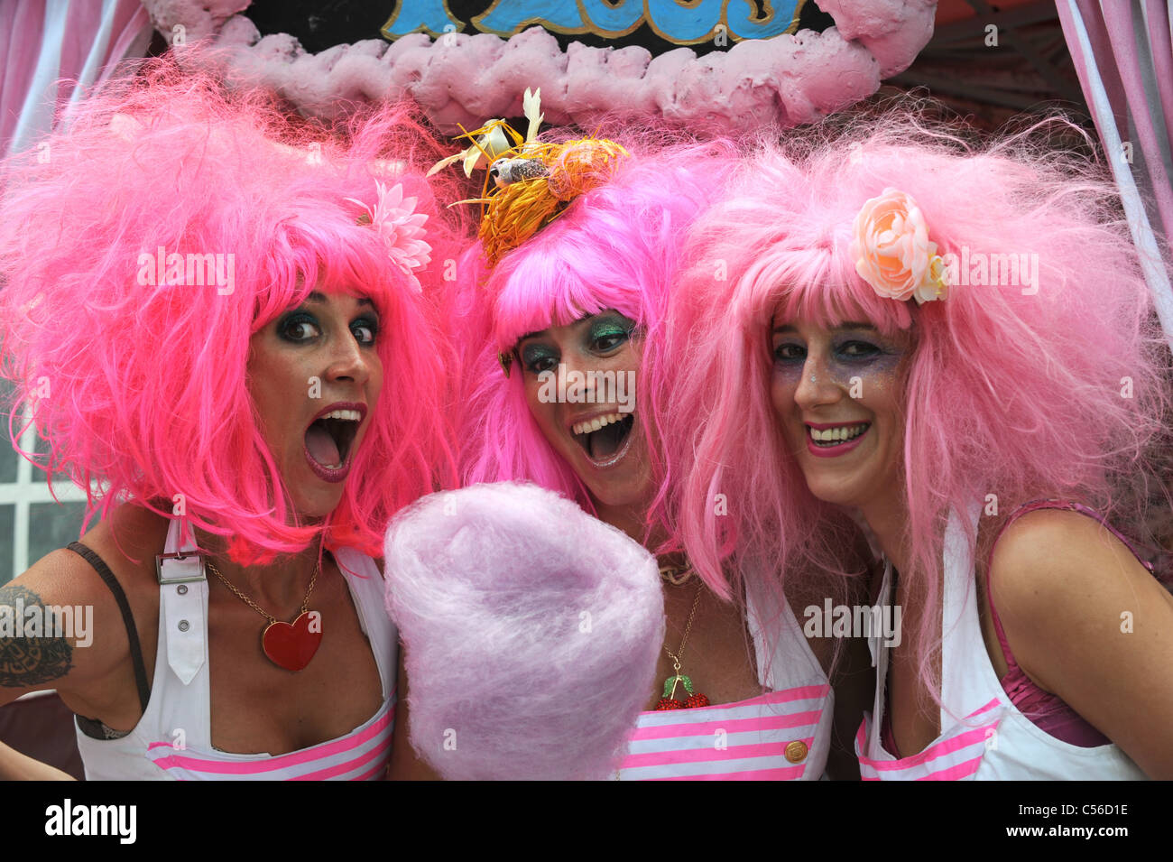 Ladies called the Candy Queens wearing pink hair wigs making and selling candy floss at the ...