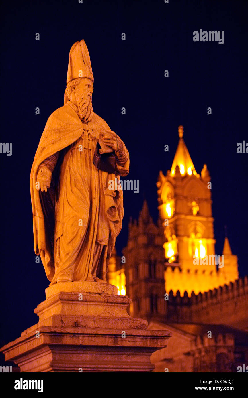 A statue of St Augustine of Canterbury and Palermo's Cathedral floodlit ...
