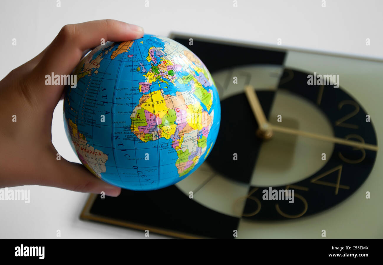 Globe and watch on background. Hand with globe Stock Photo - Alamy