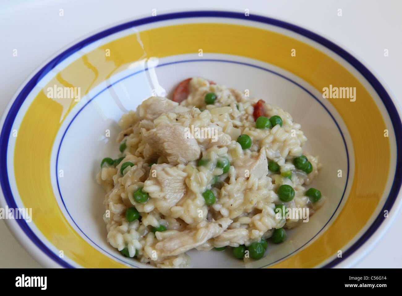 A bowl of freshly cooked chicken, chorizo and pea risotto Stock Photo ...