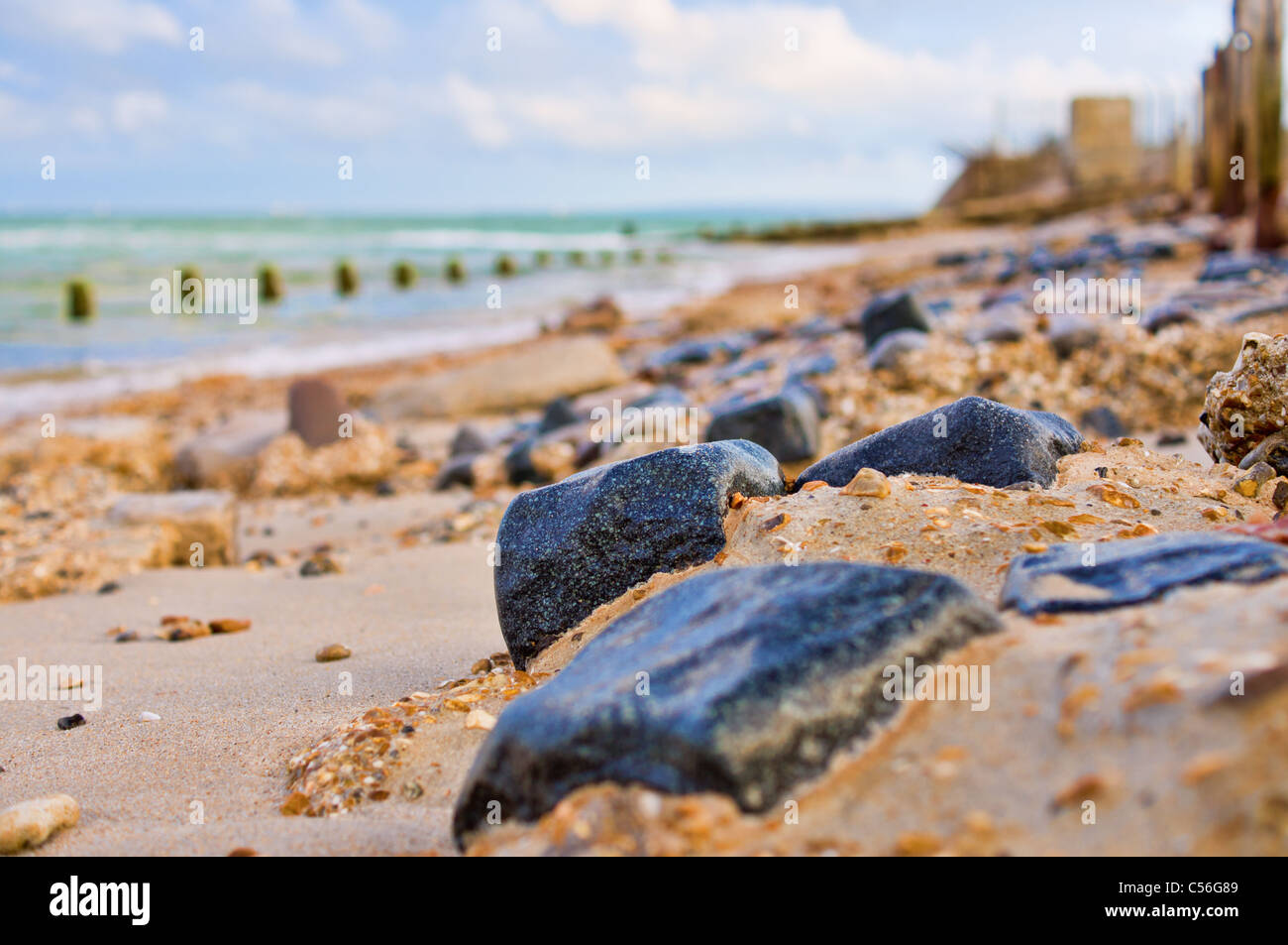 a low ground view along a stoney beach with foreground in focus with ...