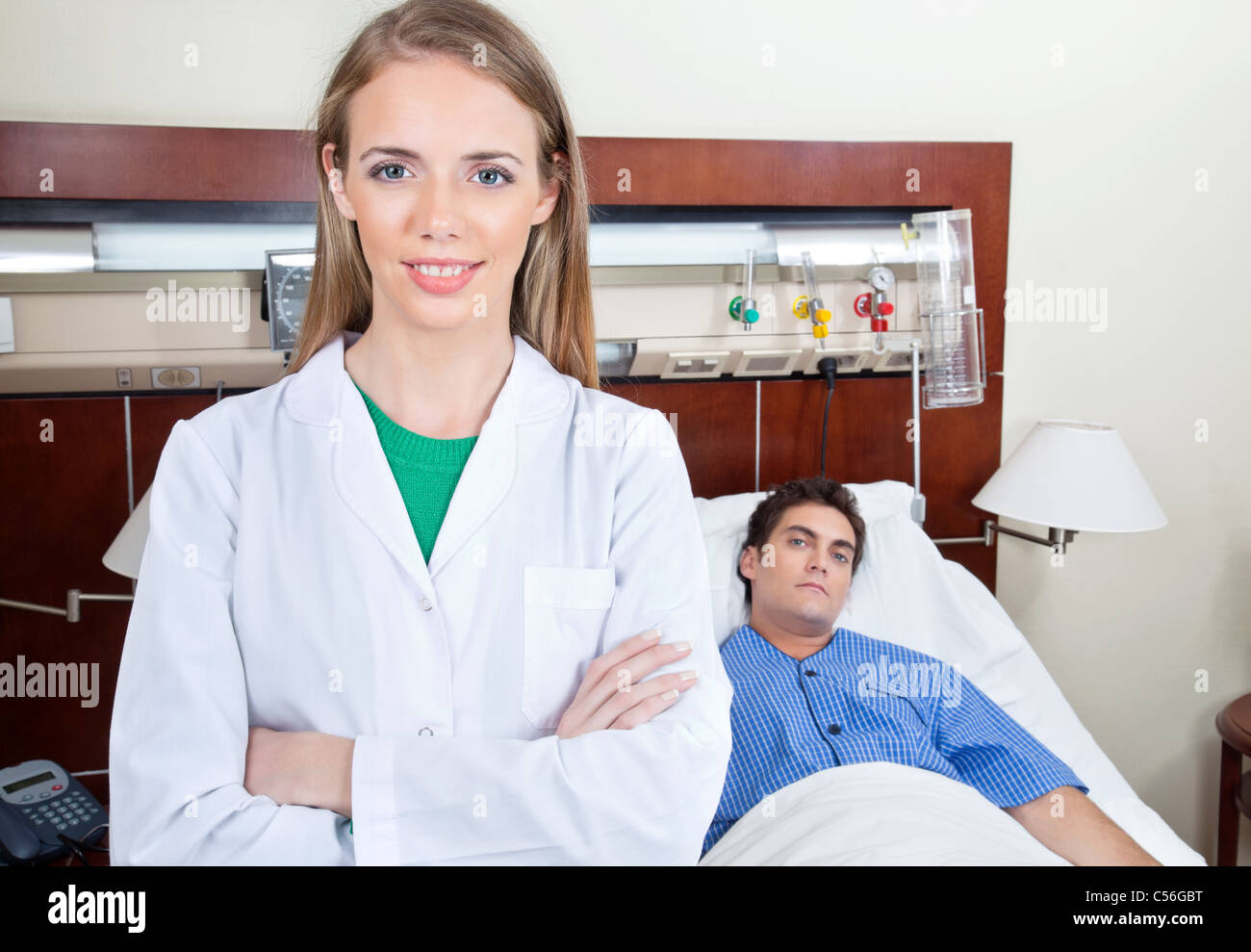 Confident female doctor with patient in hospital Stock Photo - Alamy