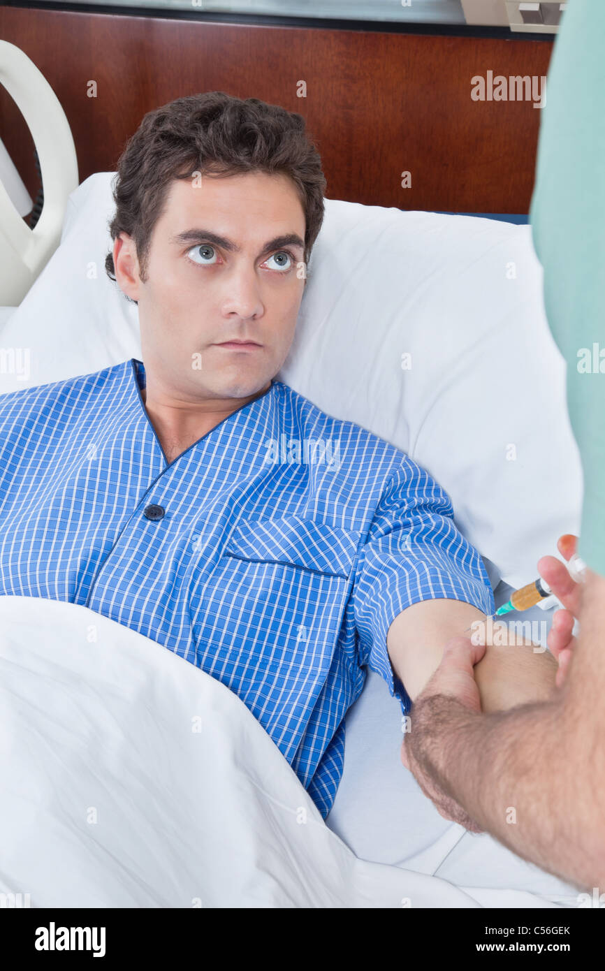 Patient staring while doctor giving vaccination Stock Photo - Alamy