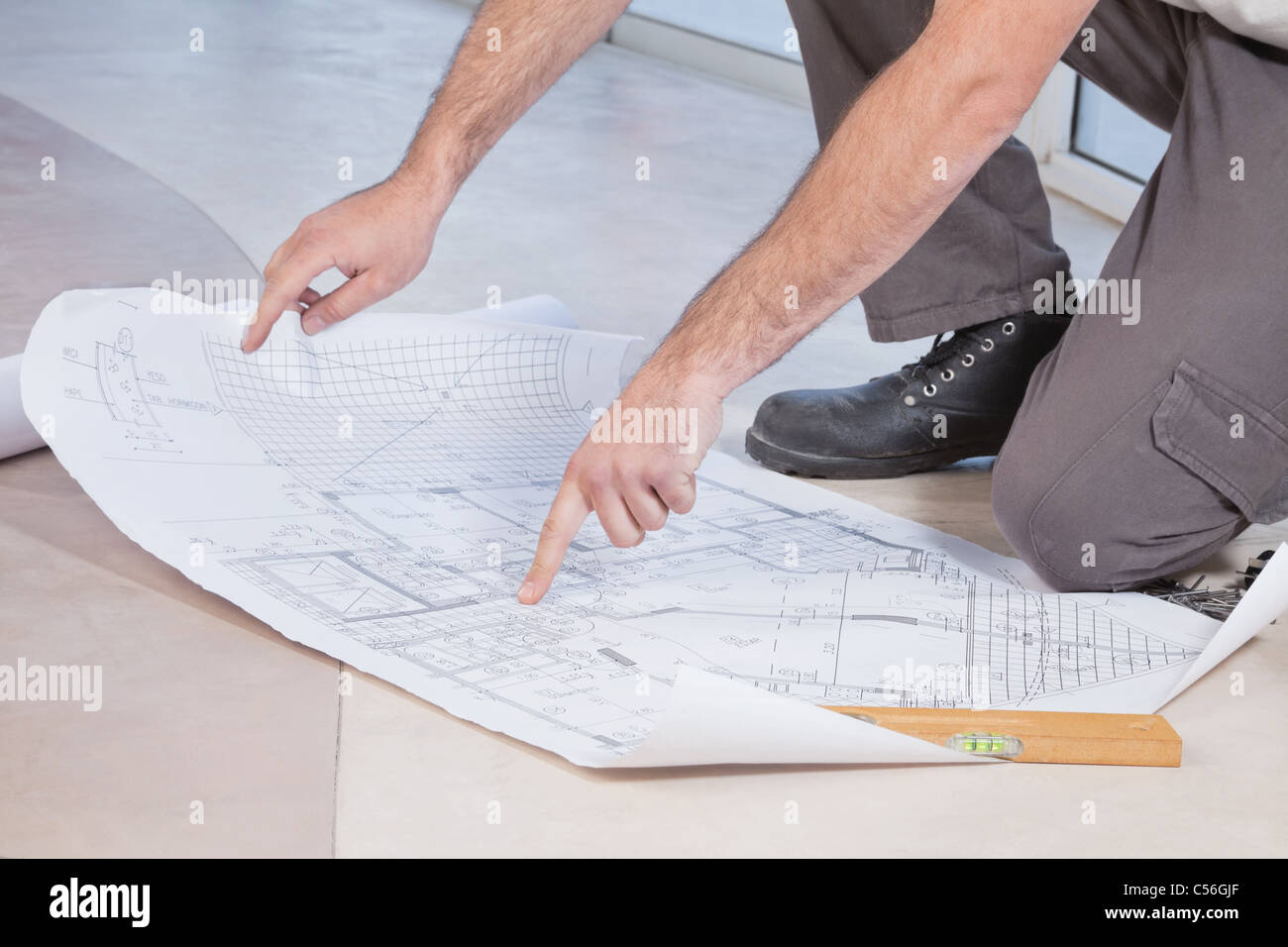 Close-up of man pointing finger at blueprint Stock Photo - Alamy