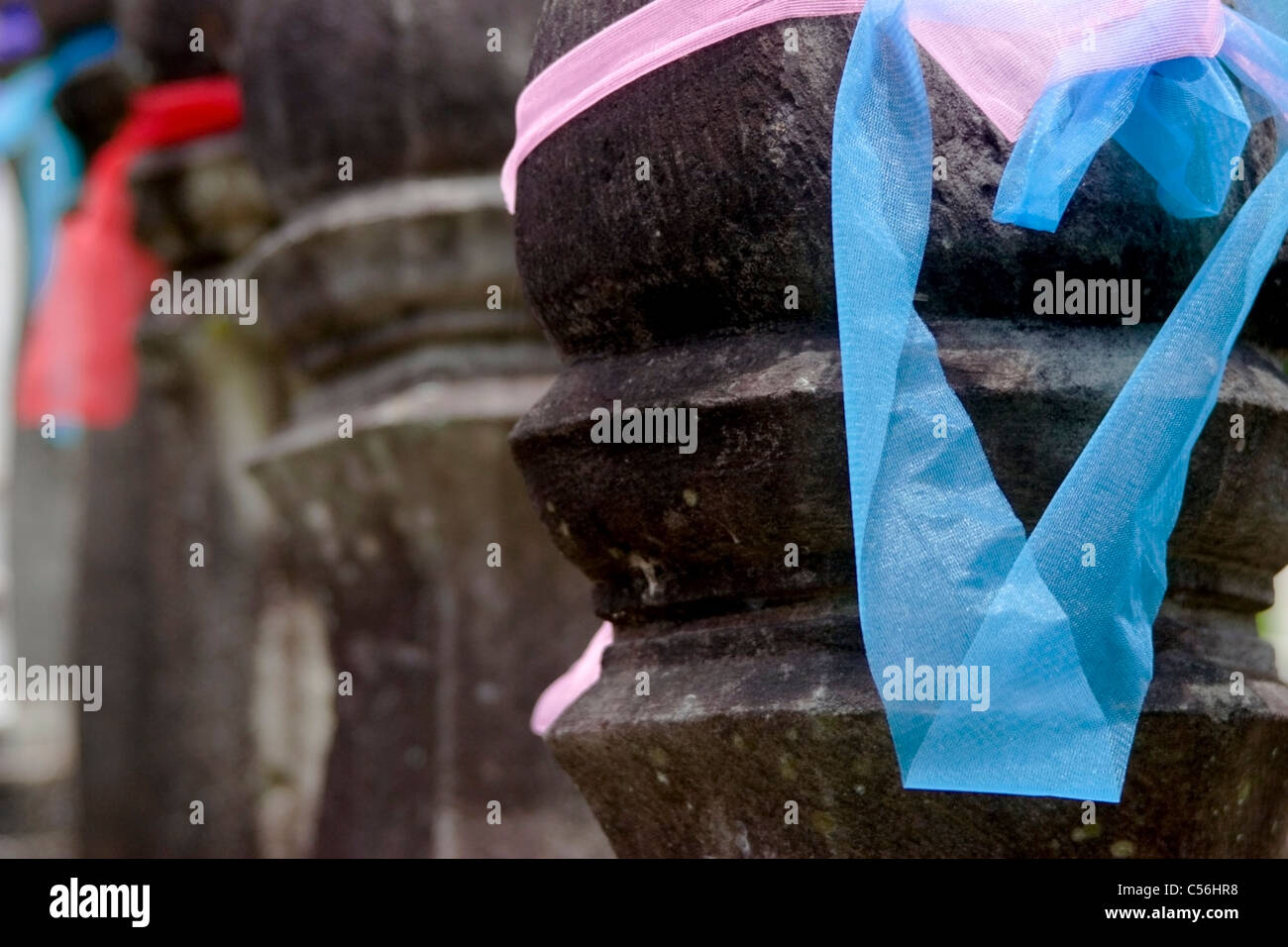 Bright and colorful ribbons are tied to pillars on the grounds of a ...