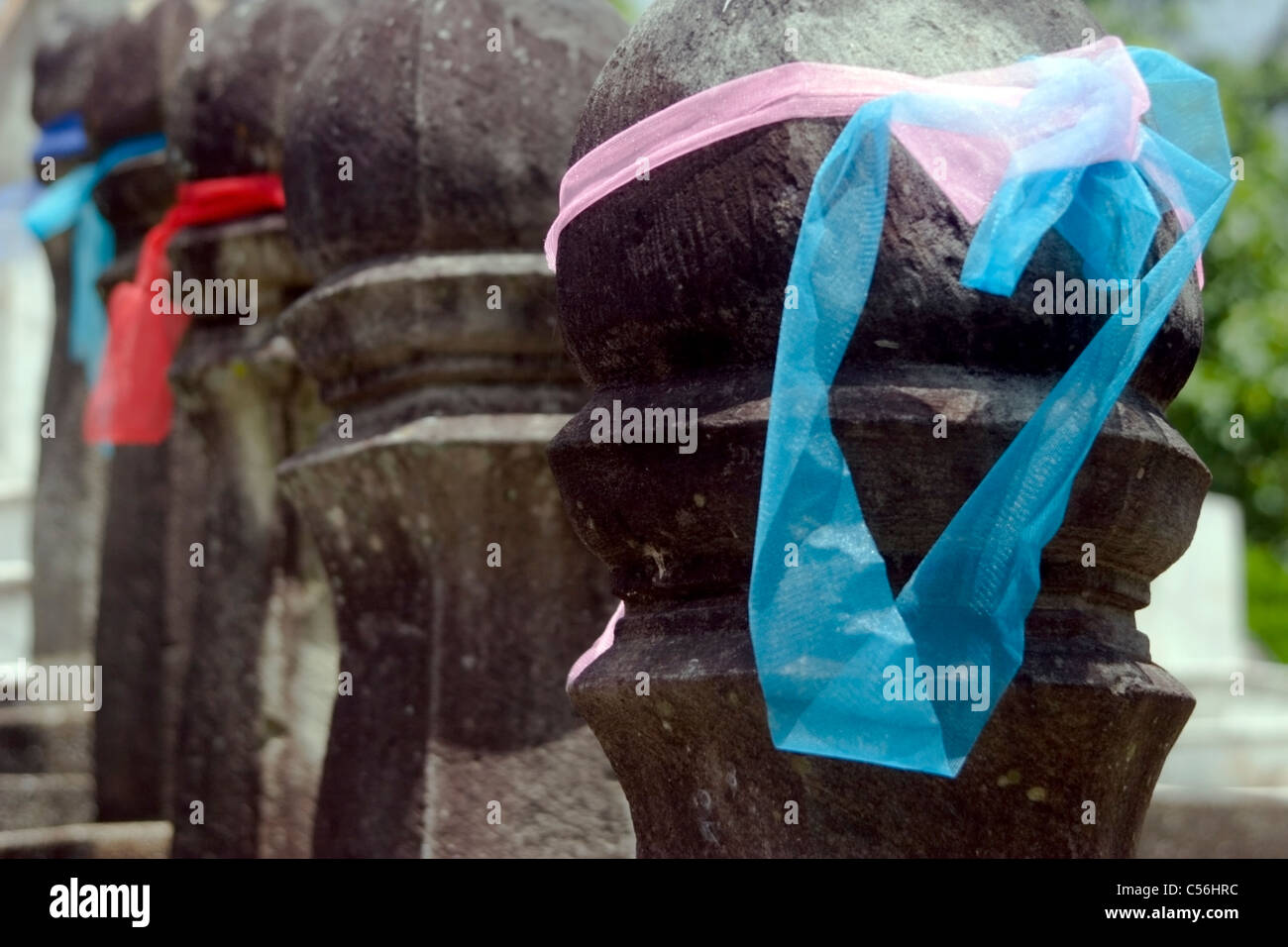 Bright and colorful ribbons are tied to pillars on the grounds of a ...