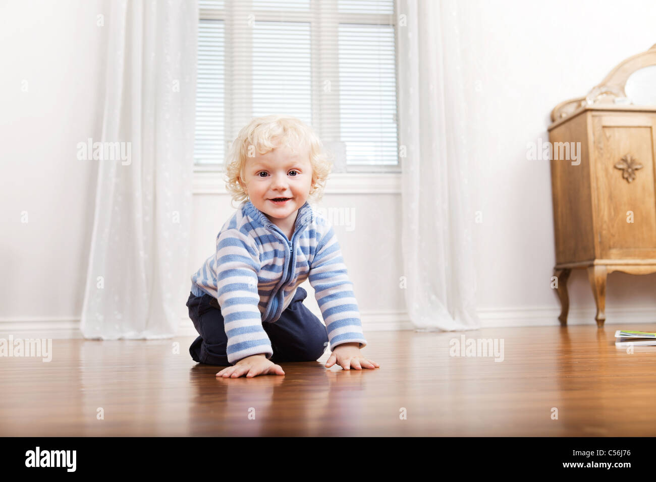Portrait of happy cute child crawling on floor Stock Photo - Alamy