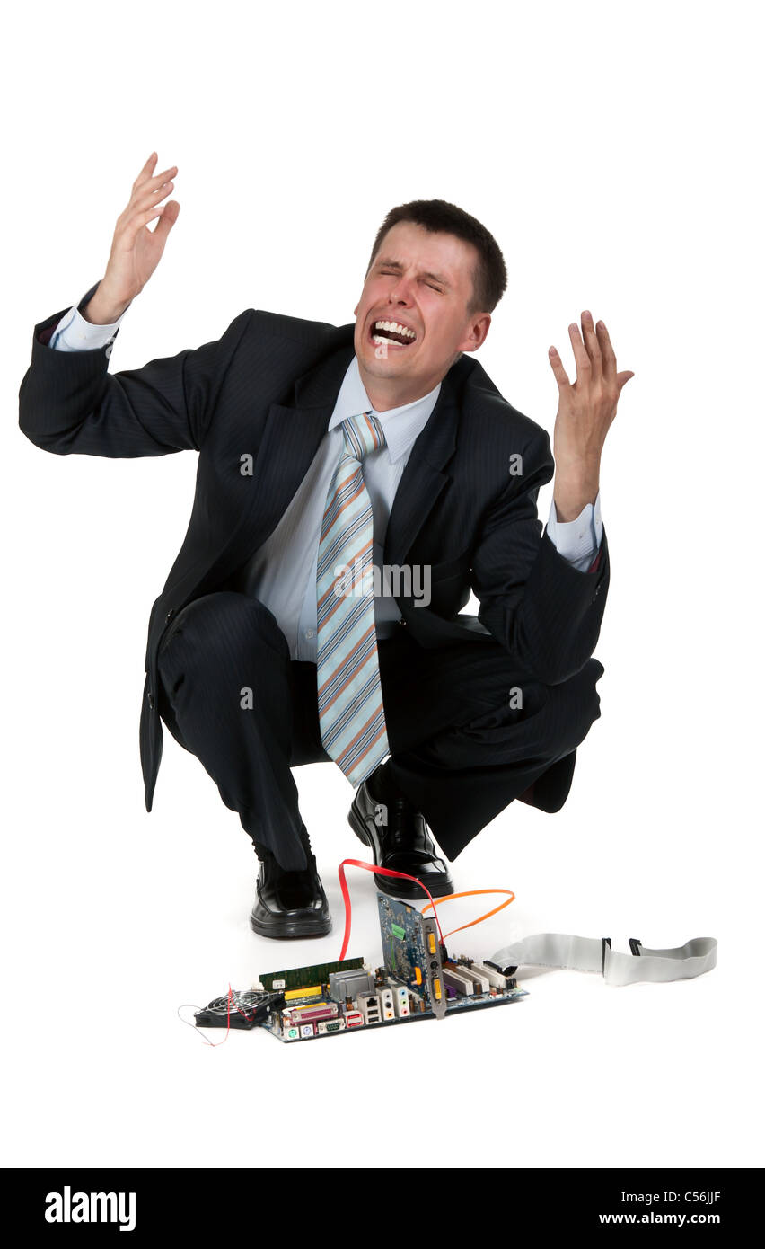 businessman is crying over the broken computer on a white background ...