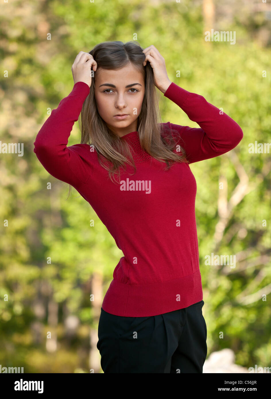 beautiful girl in a red jacket on a forest Stock Photo - Alamy