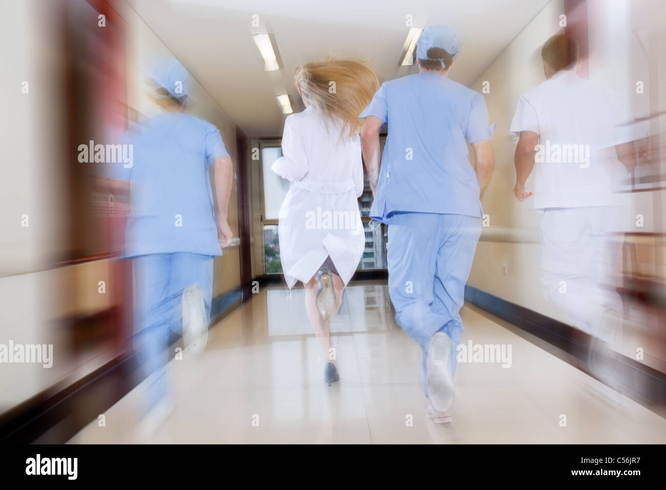 Doctor and nurse running in passageway of hospital Stock Photo - Alamy
