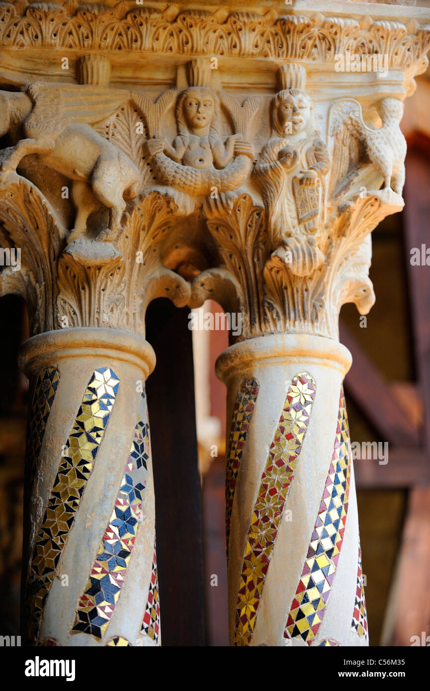A pair of columns with richly guilded mosaic inserts topped with ...