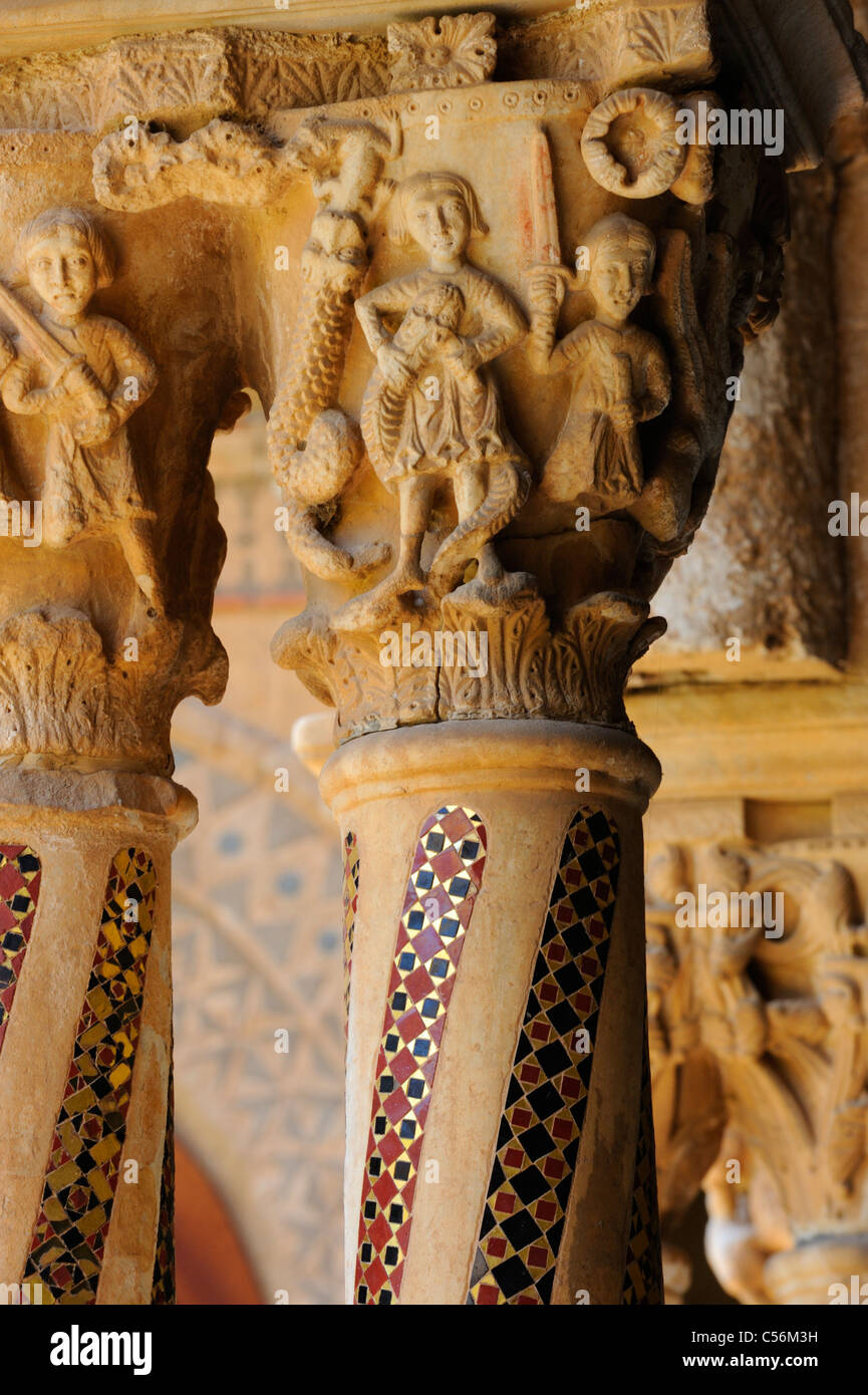 A pair of columns with richly guilded mosaic inserts topped with ...