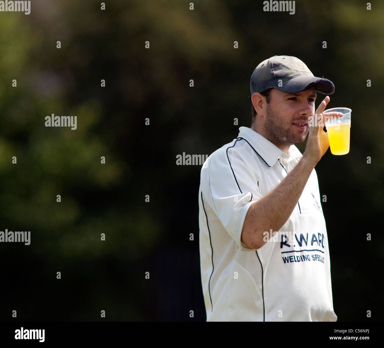 cricketer taking a drink at a break during a match Stock Photo - Alamy