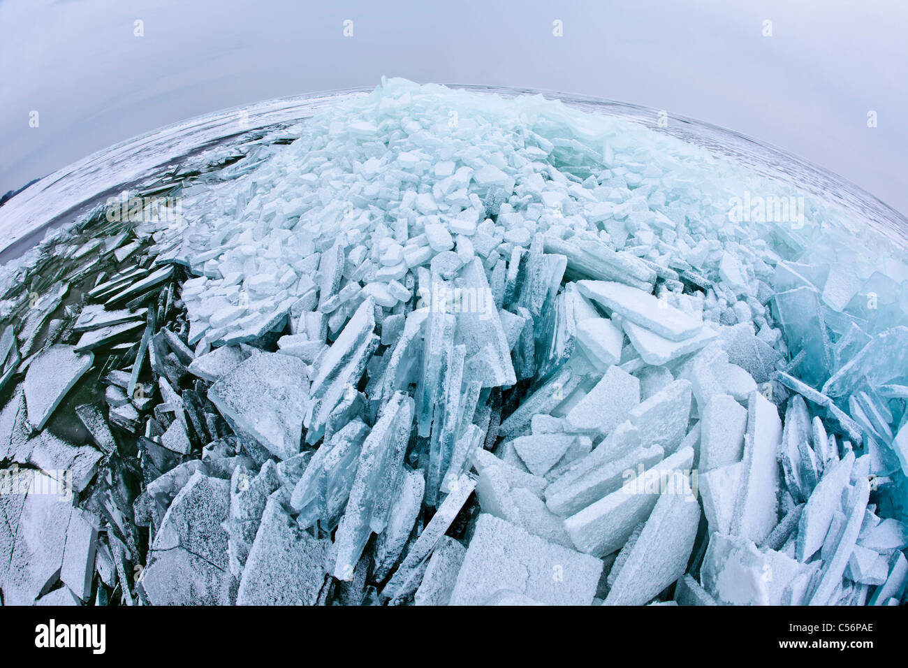 The Netherlands, Oosterleek, Piled up ice on frozen lake called ...