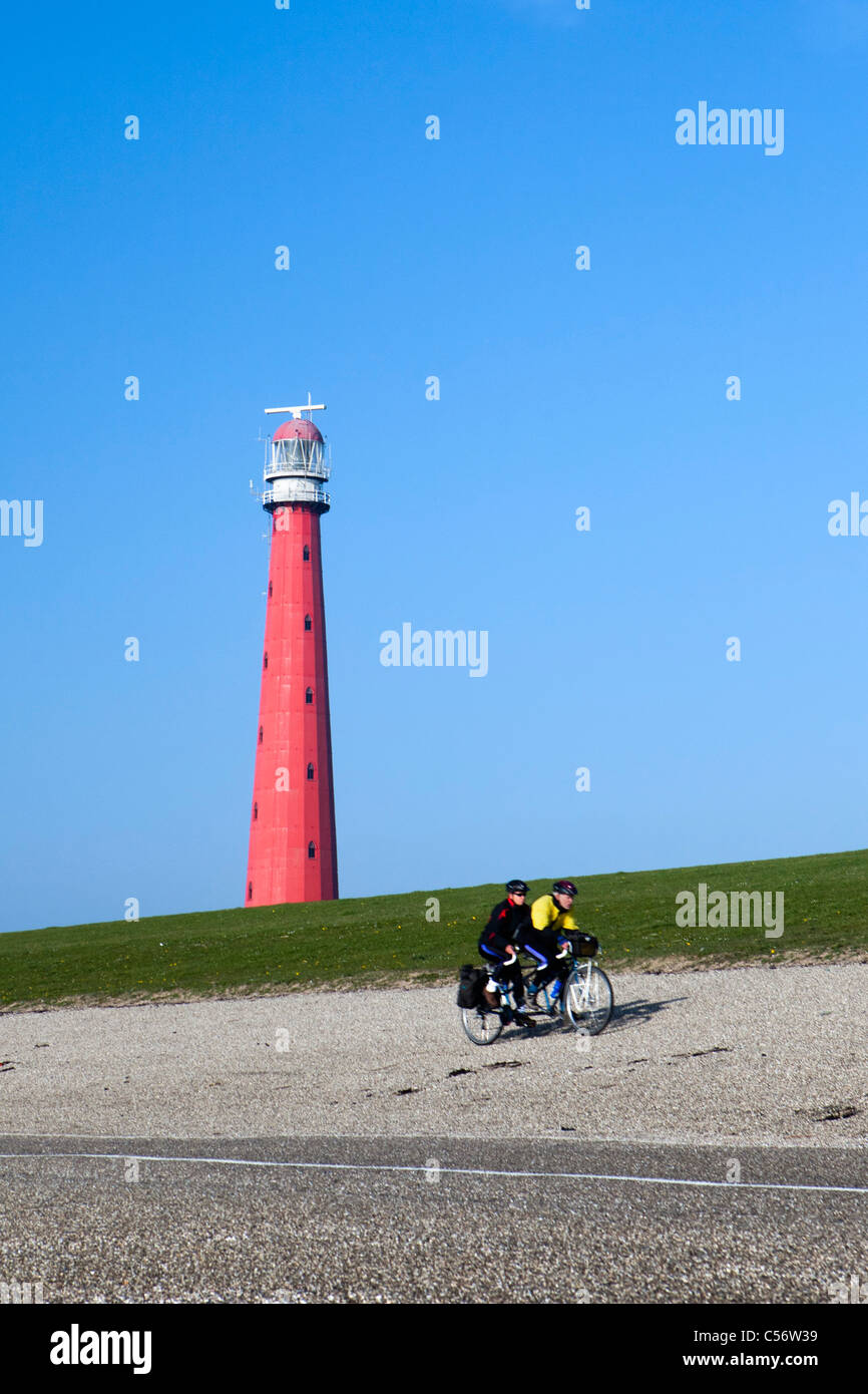 The Netherlands, Den Helder, lighthouse and cyclists, tandem Stock ...
