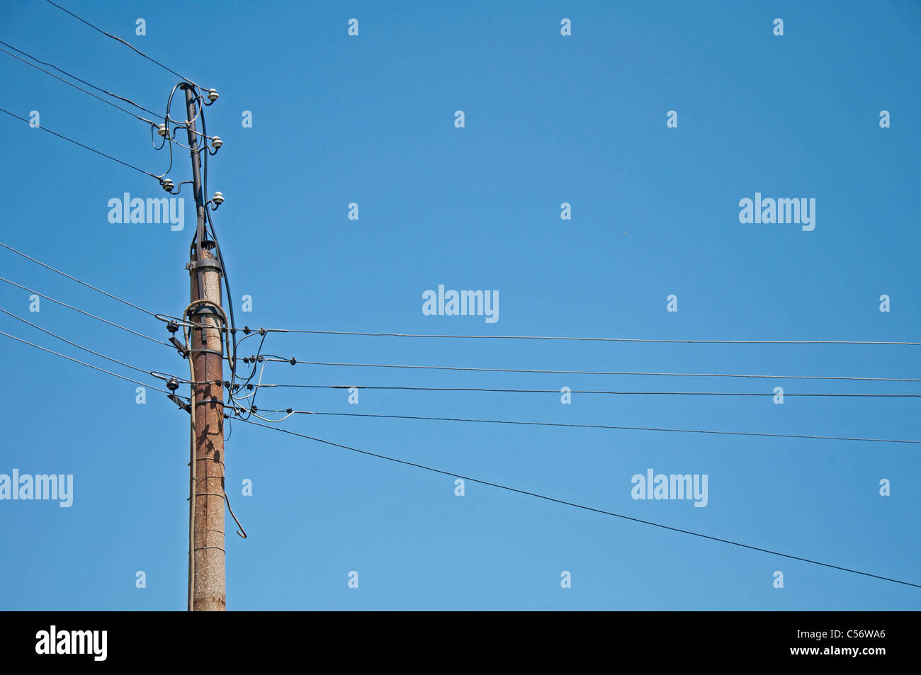 Old electrical wiring. Column on blue sky background Stock Photo - Alamy