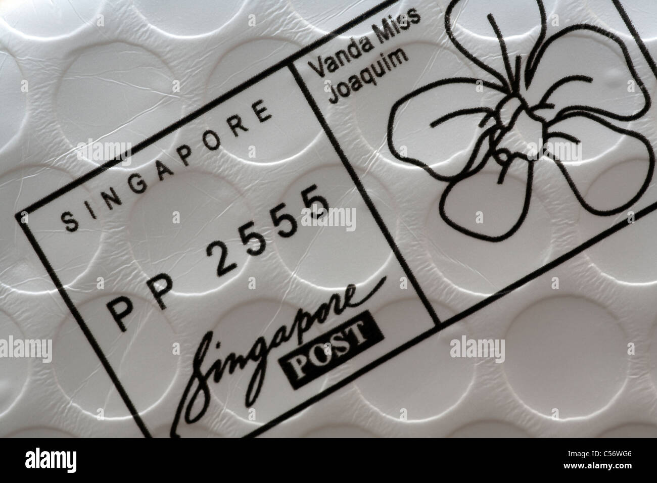 Detail of the Singaporean post mark on a white padded envelope with an ...