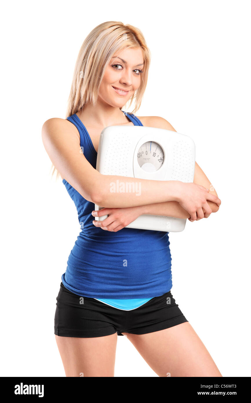 An athlete female holding a weight scale Stock Photo - Alamy