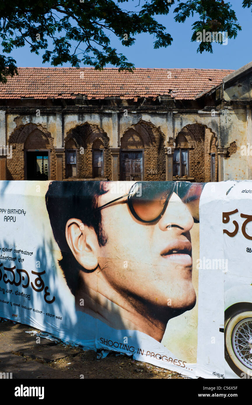 A fancy advertising billboard in front of a ruin in Mysore, Karnataka ...