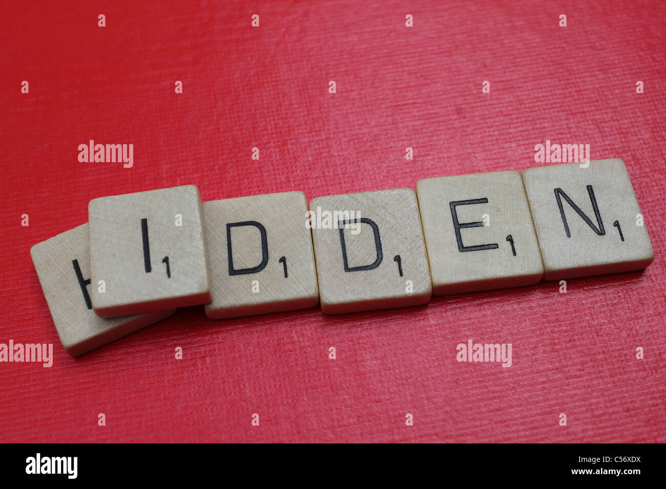 letters forming the word HIDDEN, the letter H being hidden under the I ...