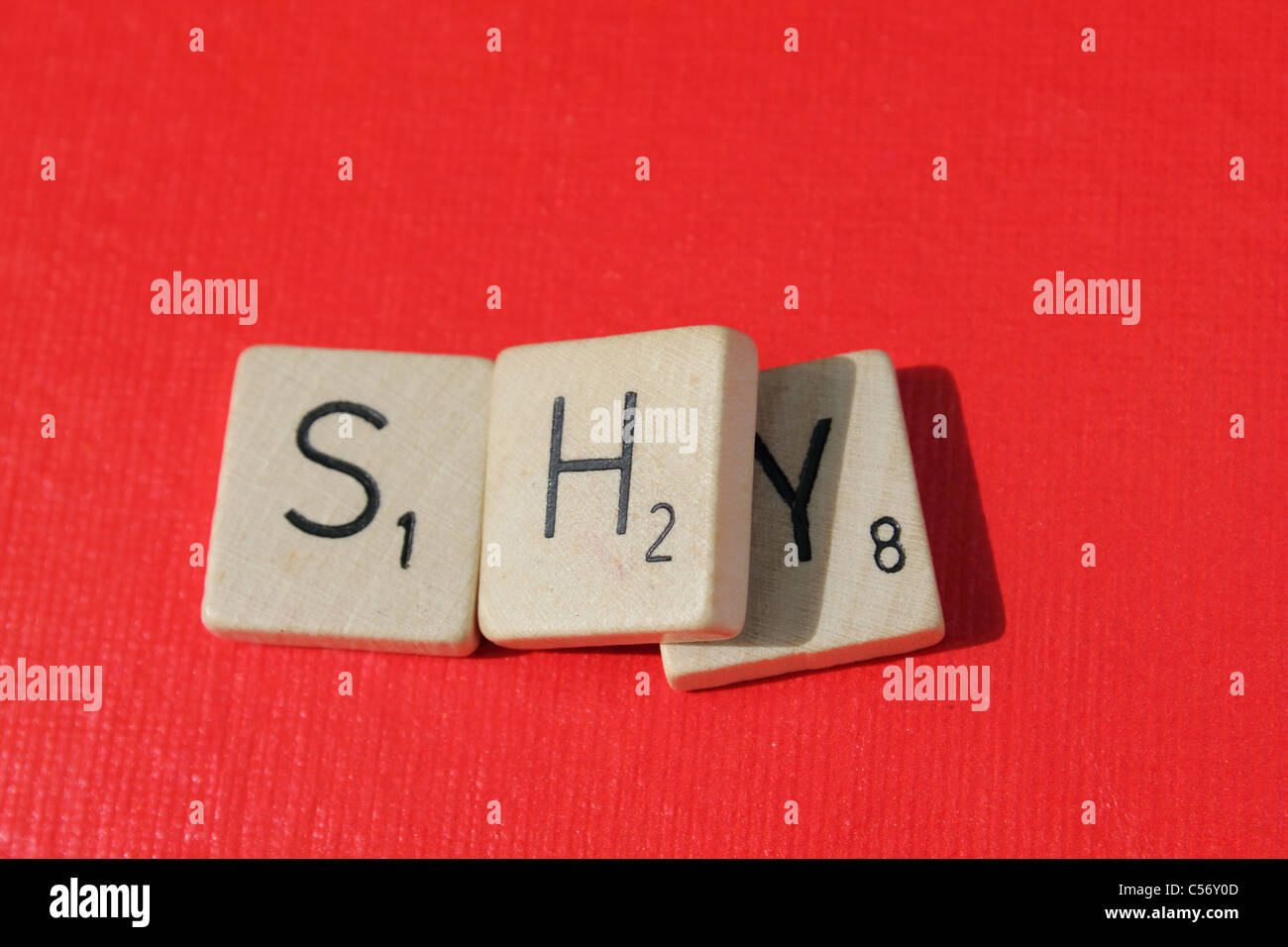 letters forming the word SHY - the letter Y is half hiding behind the ...