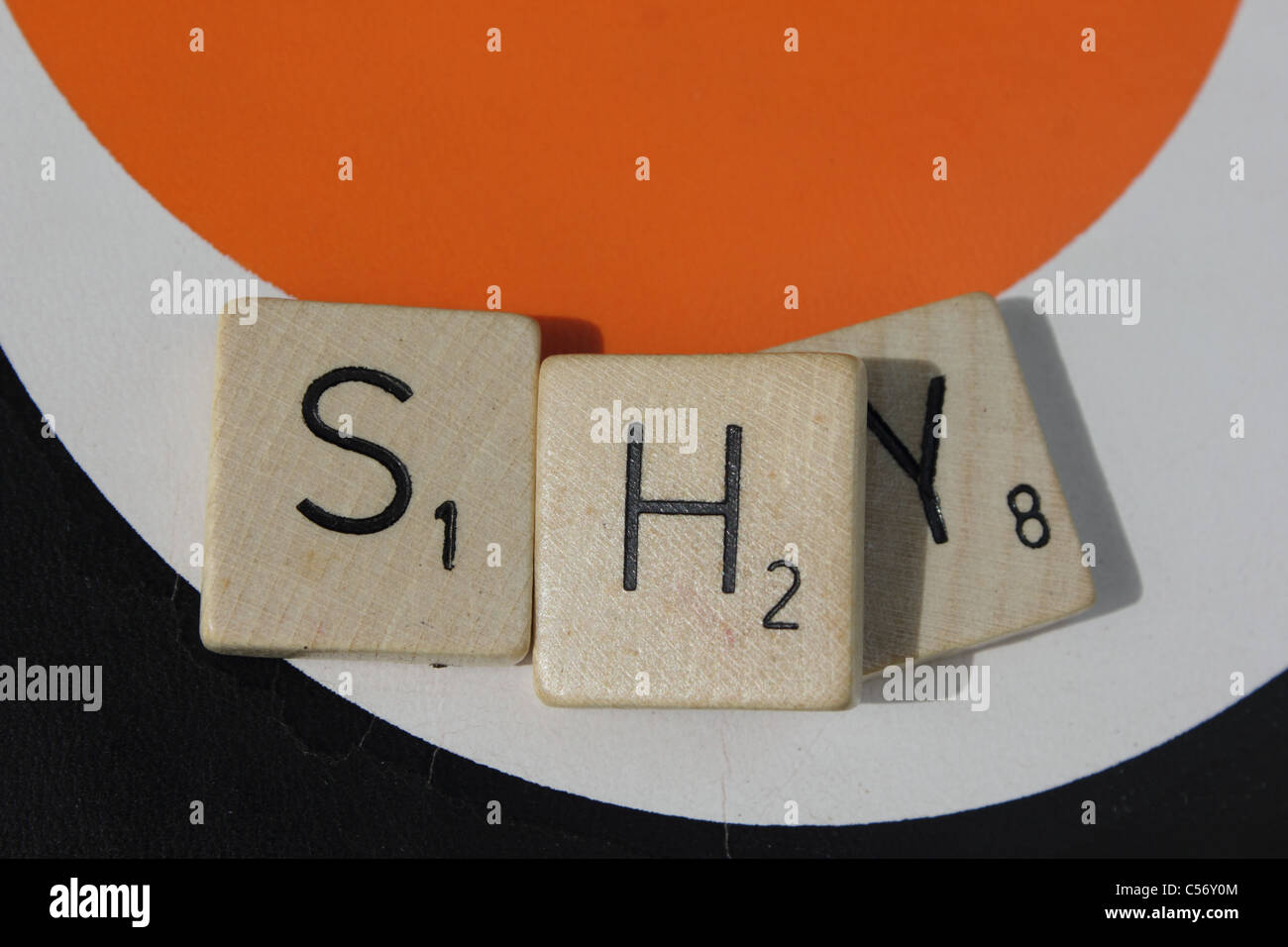 letters forming the word SHY - the letter Y is half hiding behind the ...