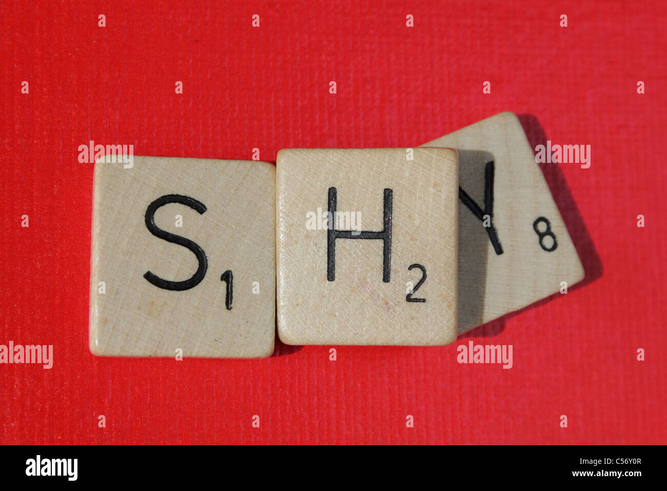 letters forming the word SHY - the letter Y is half hiding behind the ...