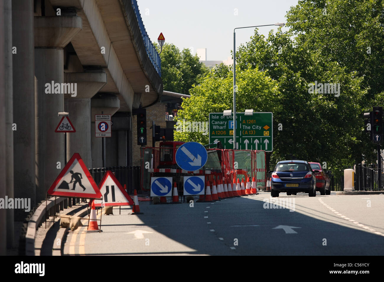 Vehicles passing roadworks signs and cones Stock Photo - Alamy