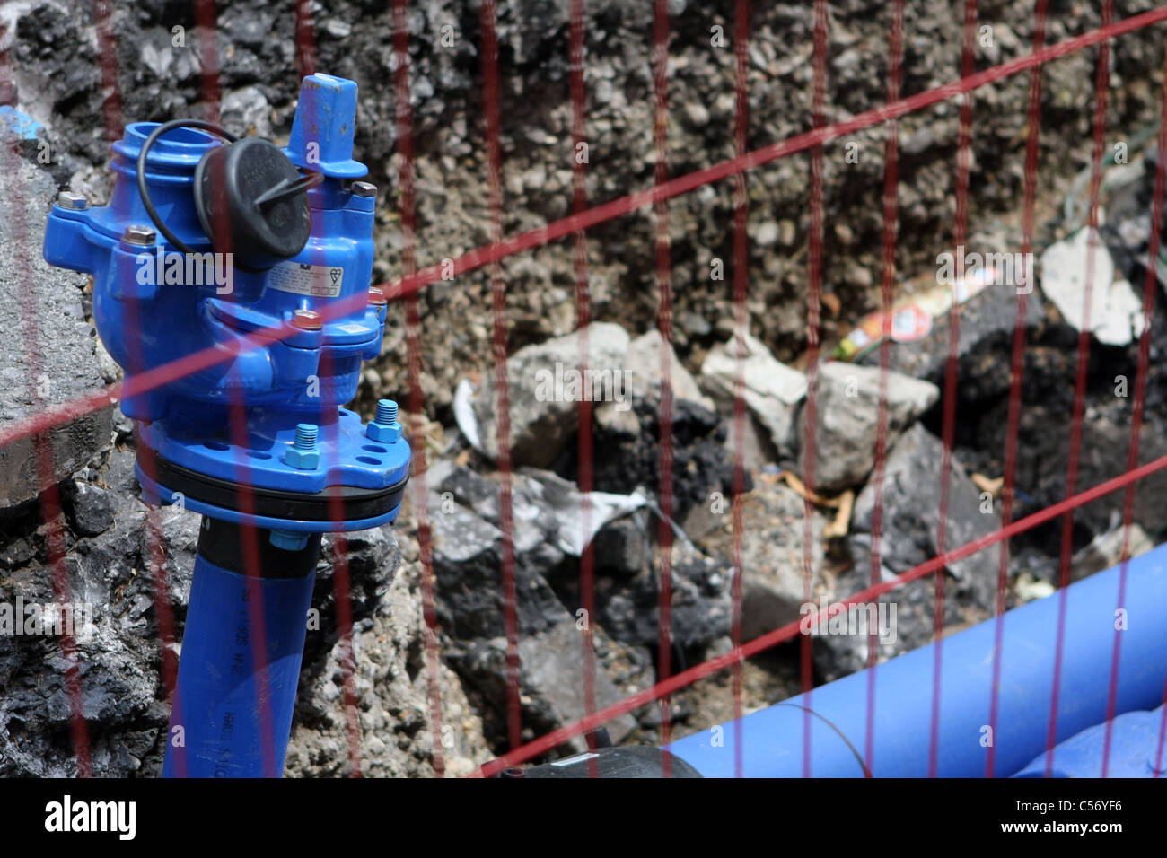 A blue water pipe valve in a hole in roadworks in London Stock Photo ...