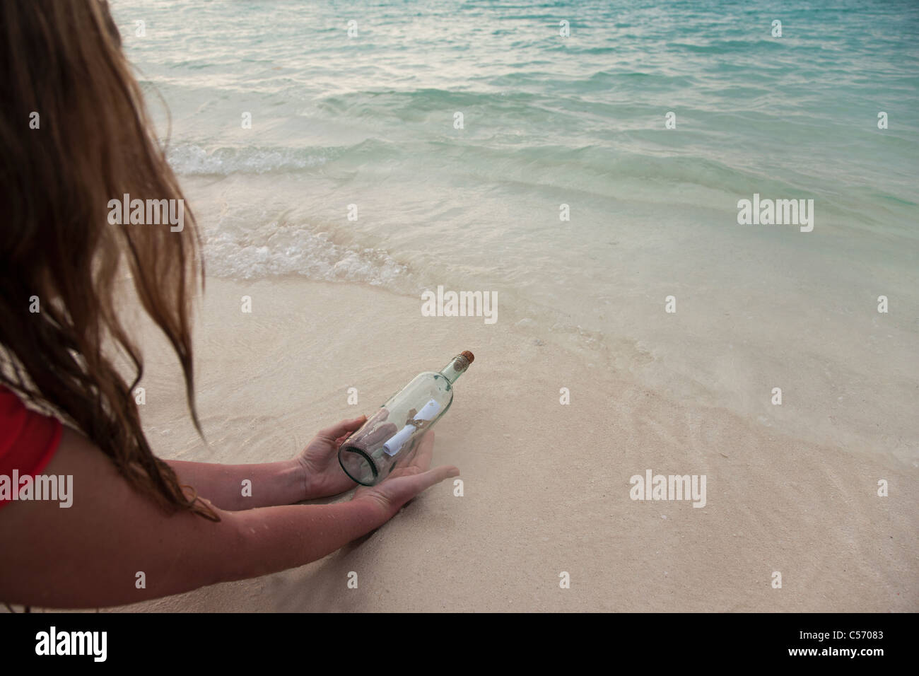 Woman with message in a bottle at beach Stock Photo - Alamy
