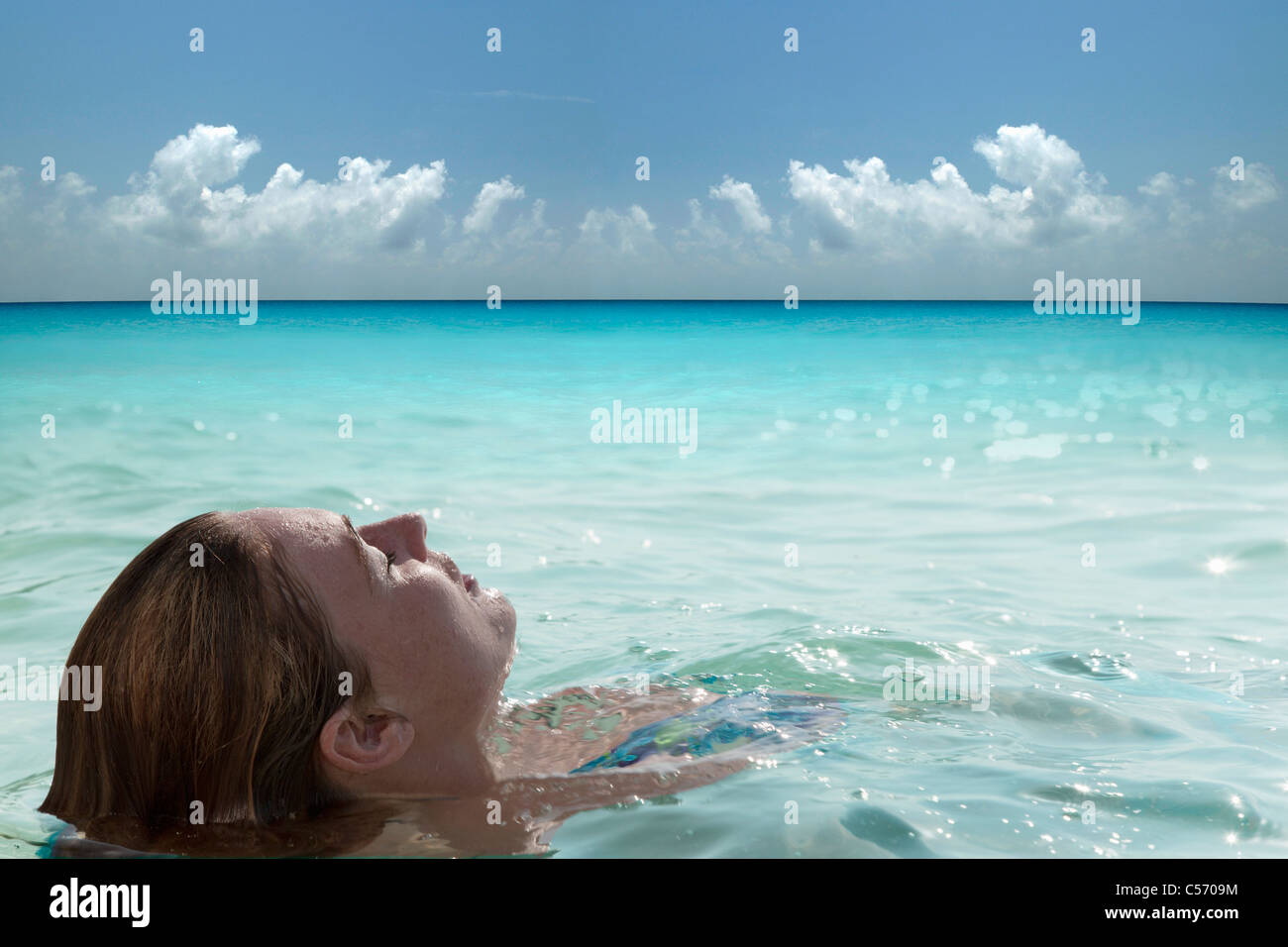 Woman floating in calm sea Stock Photo - Alamy