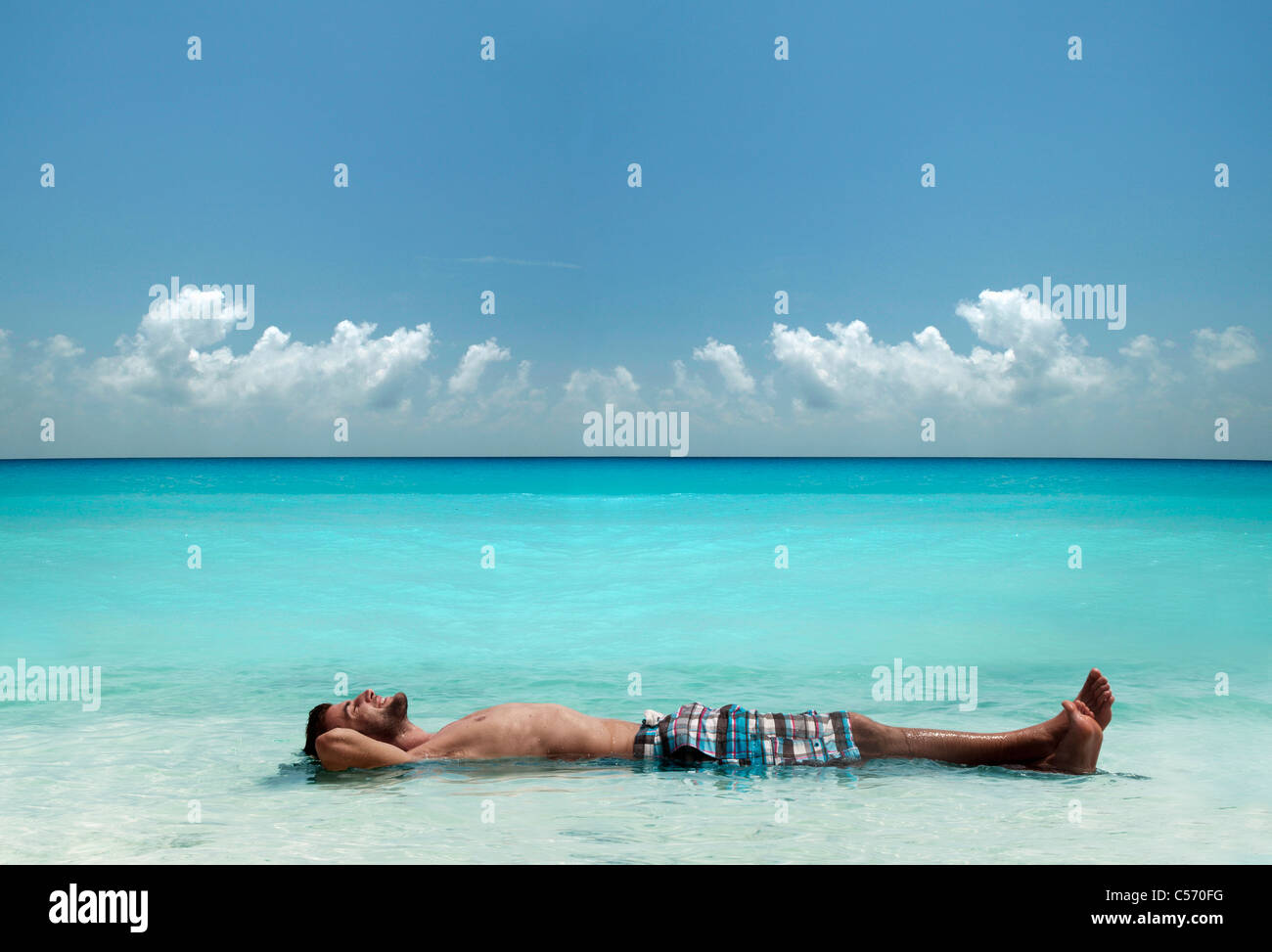 Man floating in water at tropical beach Stock Photo - Alamy