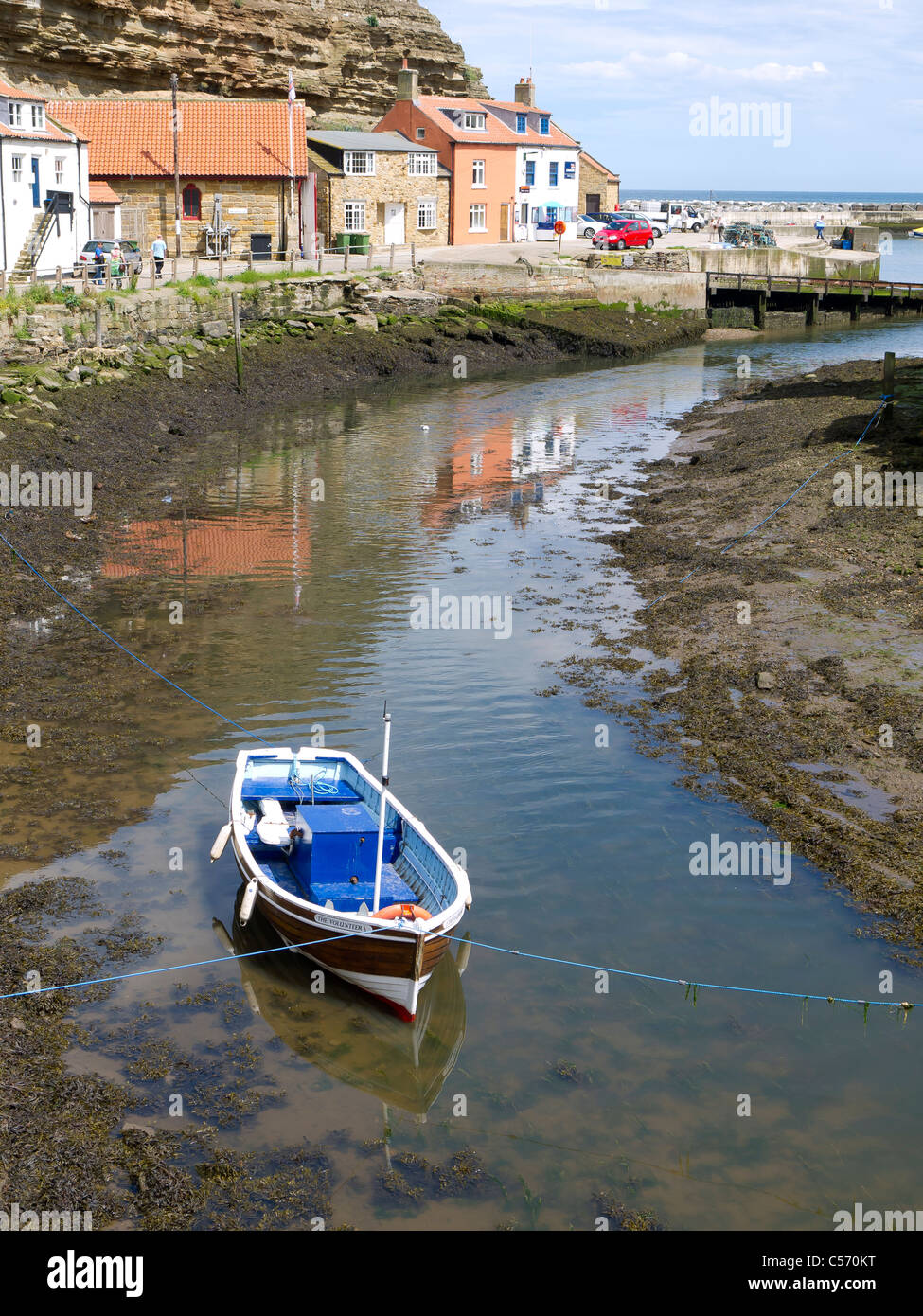 A small fishing boat moored in Roxby Beck Staithes Harbour North ...