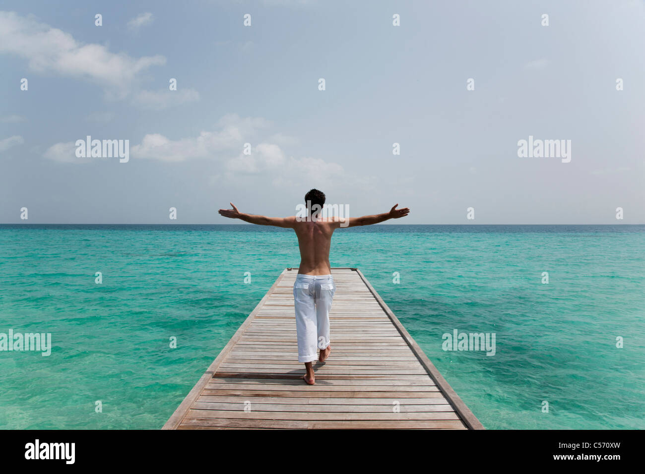 Man walking on deck overlooking sea Stock Photo - Alamy