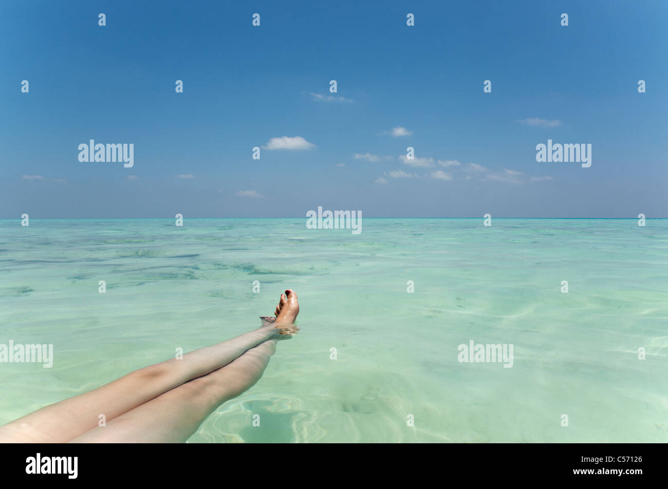 Woman’s legs floating in tropical sea Stock Photo - Alamy